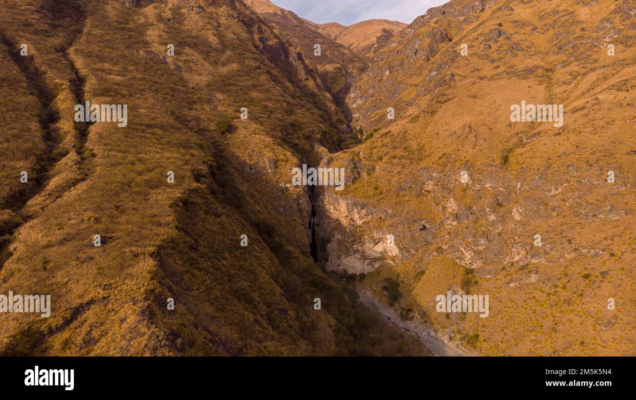 A drone shot of high hills covered with dry grass, cool,for background ...
