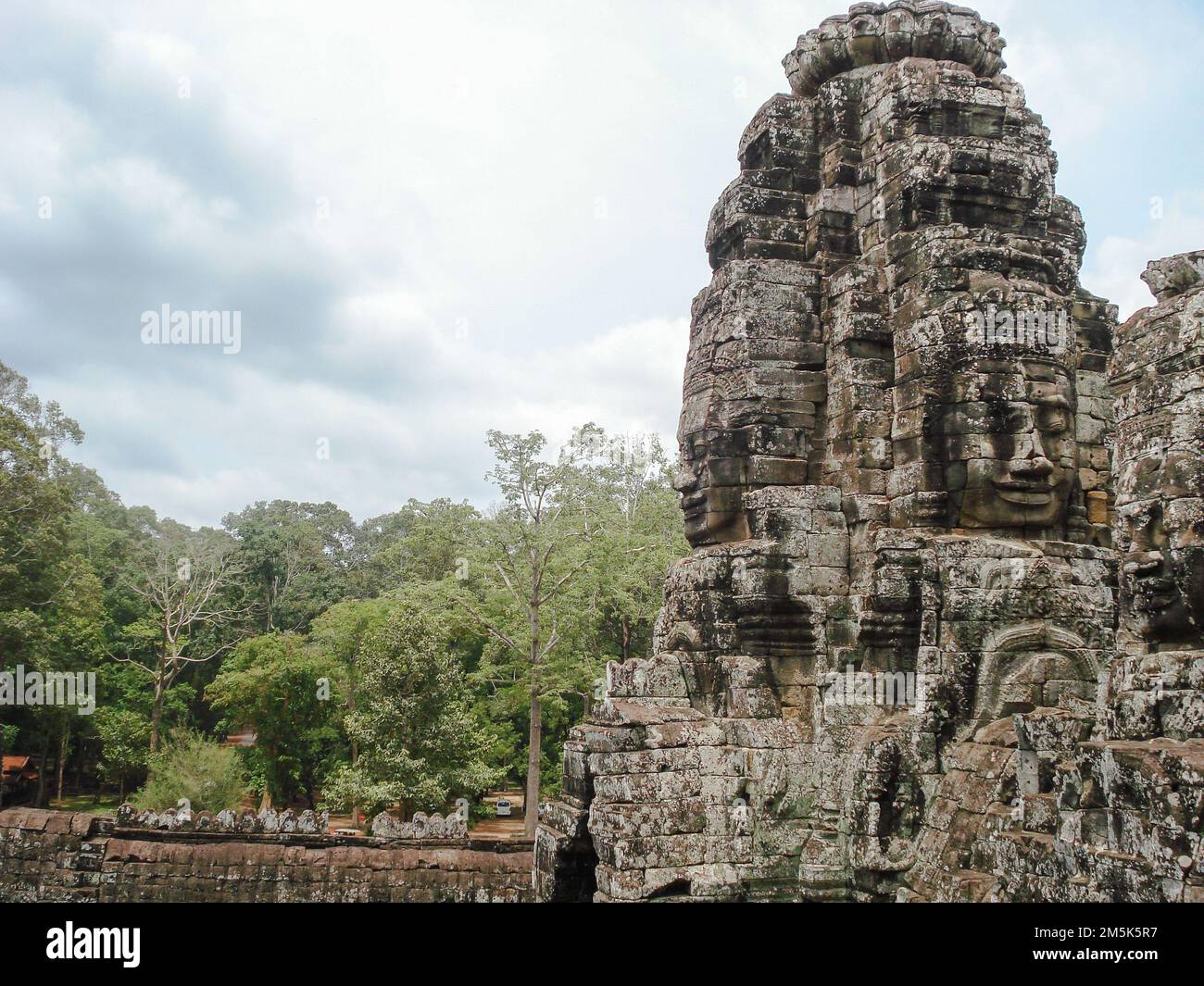 An image of a stone statue in front of trees in Angkor Wat, Cambodia ...
