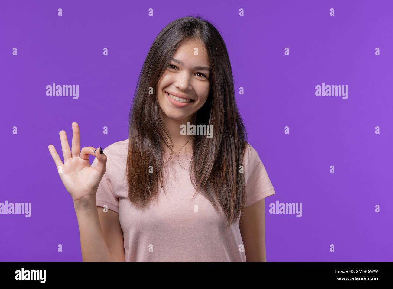 Pretty woman makes hand sign okay, ok gesture. Happy teen girl, correct ...