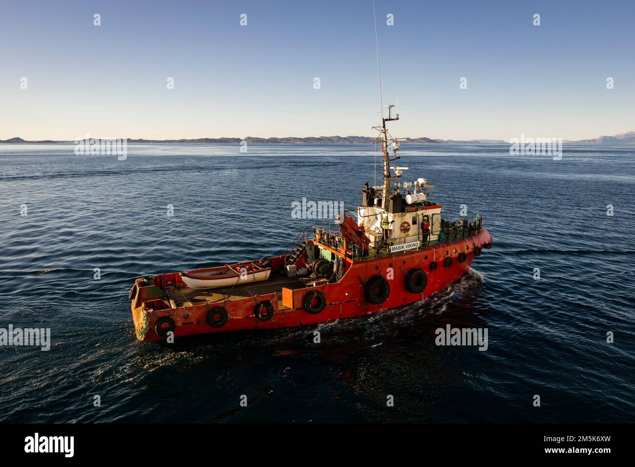 Tug and pilot vessel Masik Viking leading a ship into the port of Nuuk ...