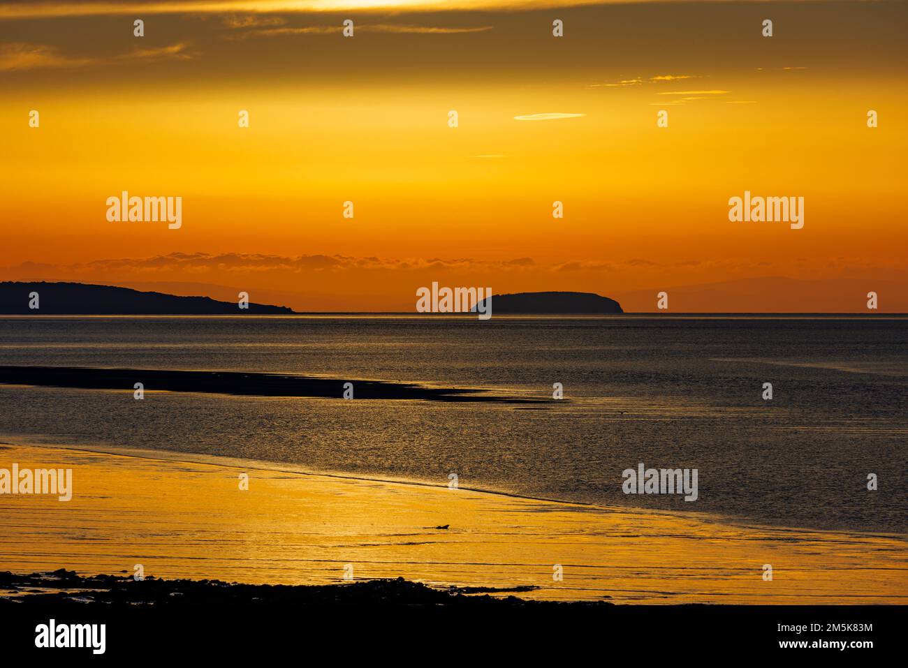 The setting sun lighting up the horizon Stock Photo - Alamy