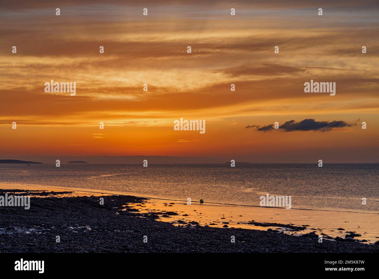 The setting sun lighting up the horizon Stock Photo - Alamy