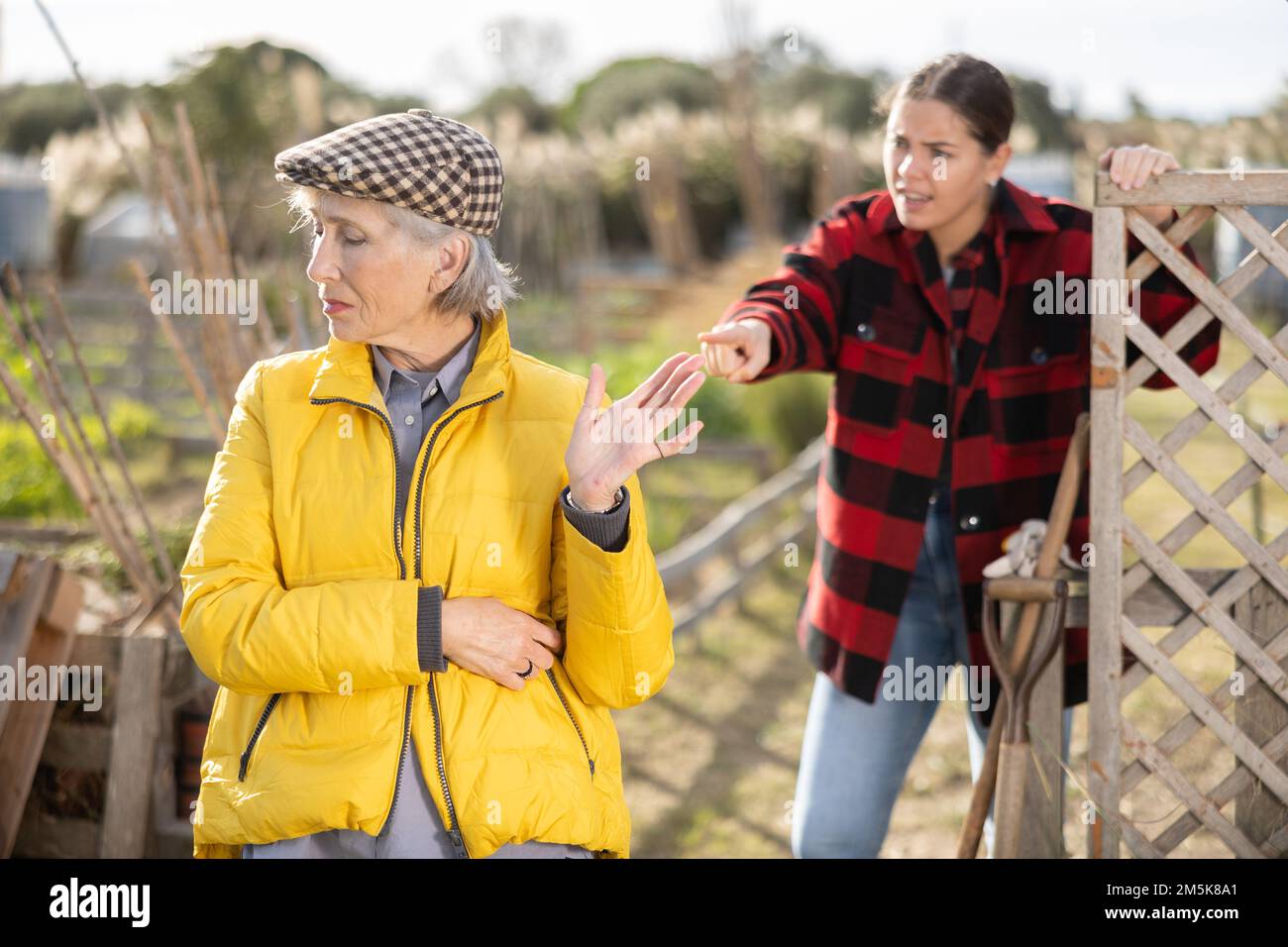 Two angry casual women neighbors of different ages arguing during the ...