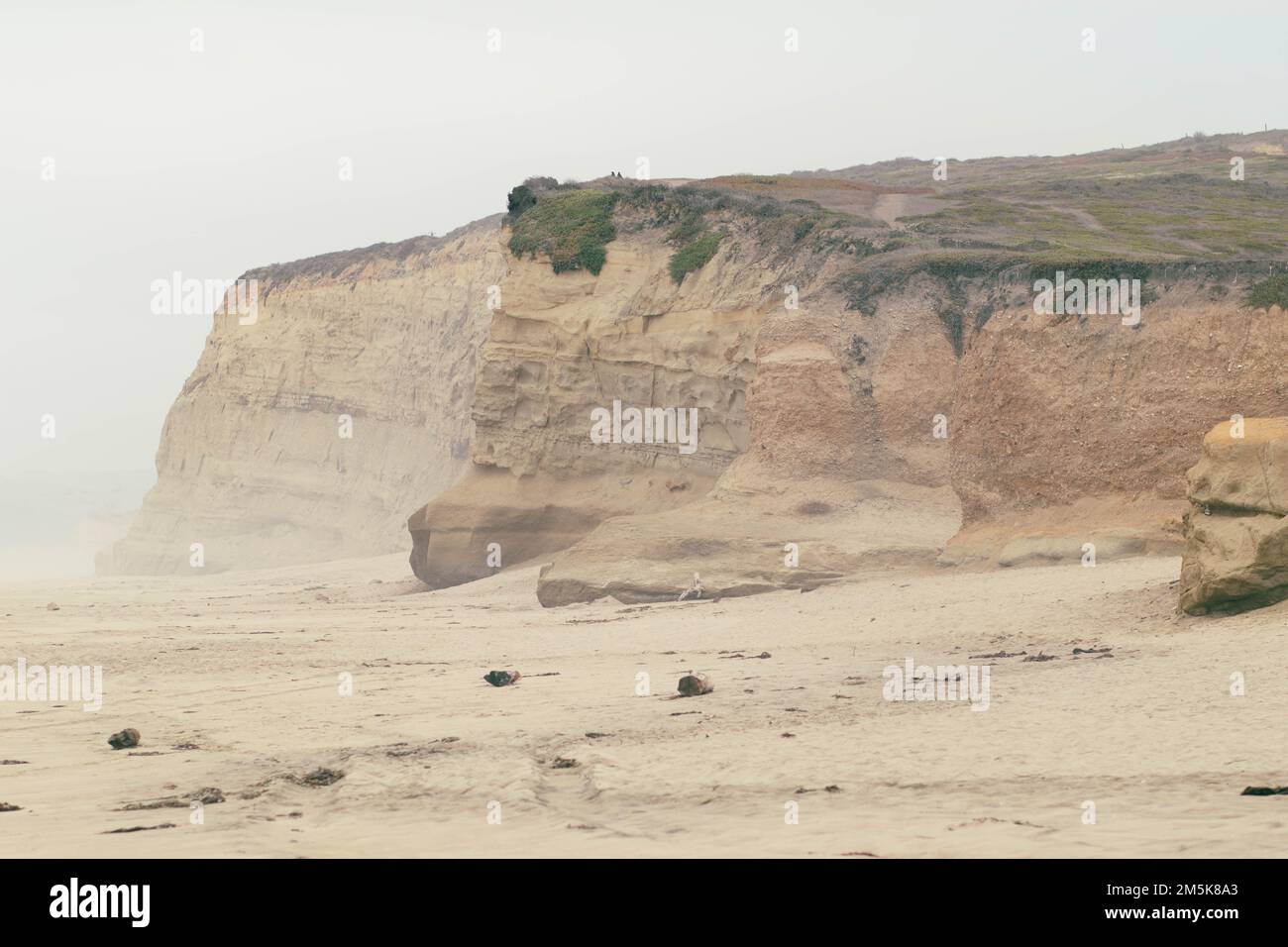 A coastal landscape with a sandy beach and rocky cliffs Stock Photo - Alamy