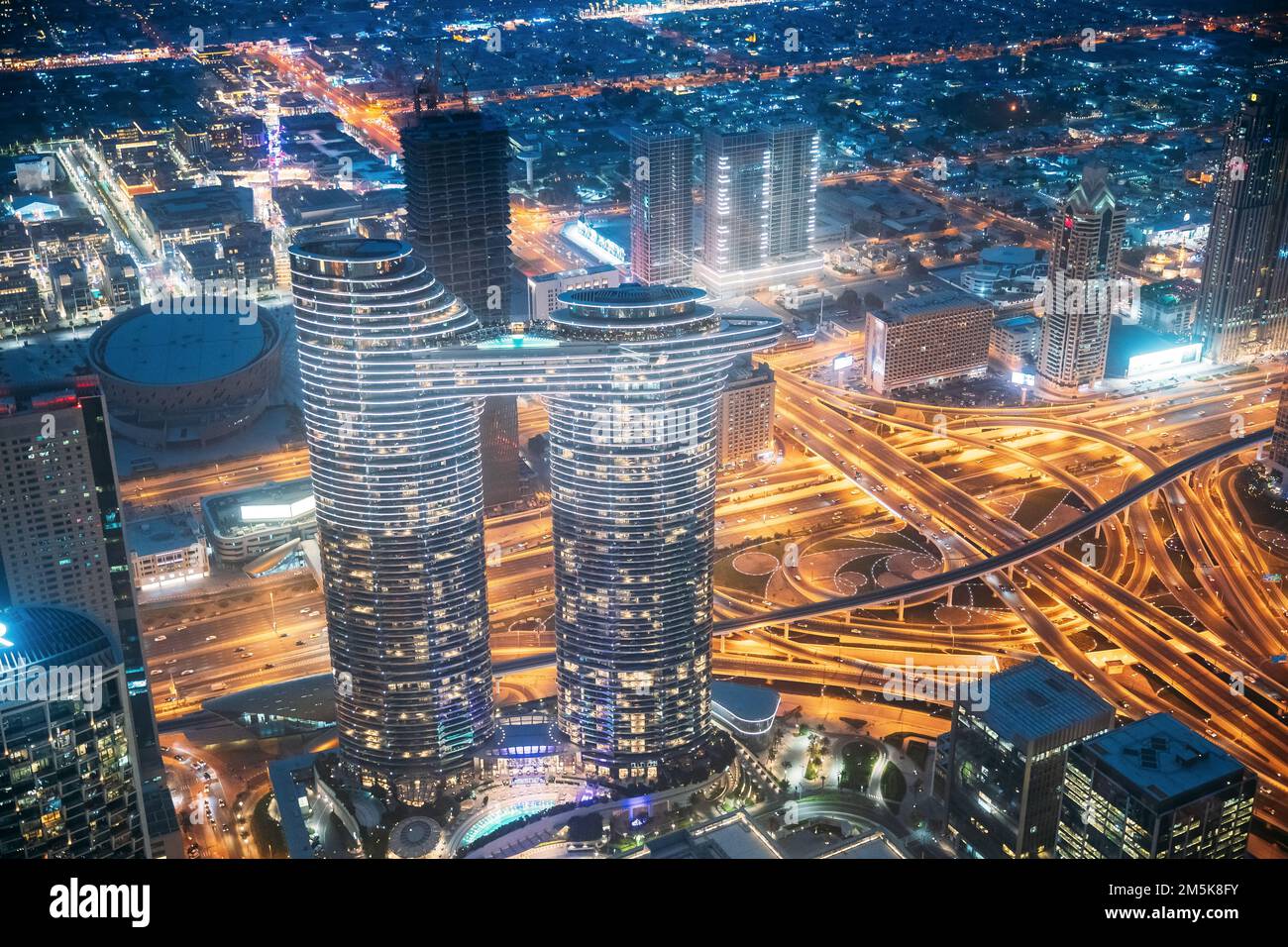 Aerial bird's-eye view of Dubai cityscape skyline. Night traffic in residential district of ...