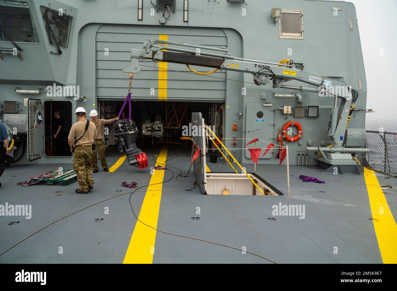 Sailors onboard the Royal Danish Navy patrol ship HDMS Triton using a ...