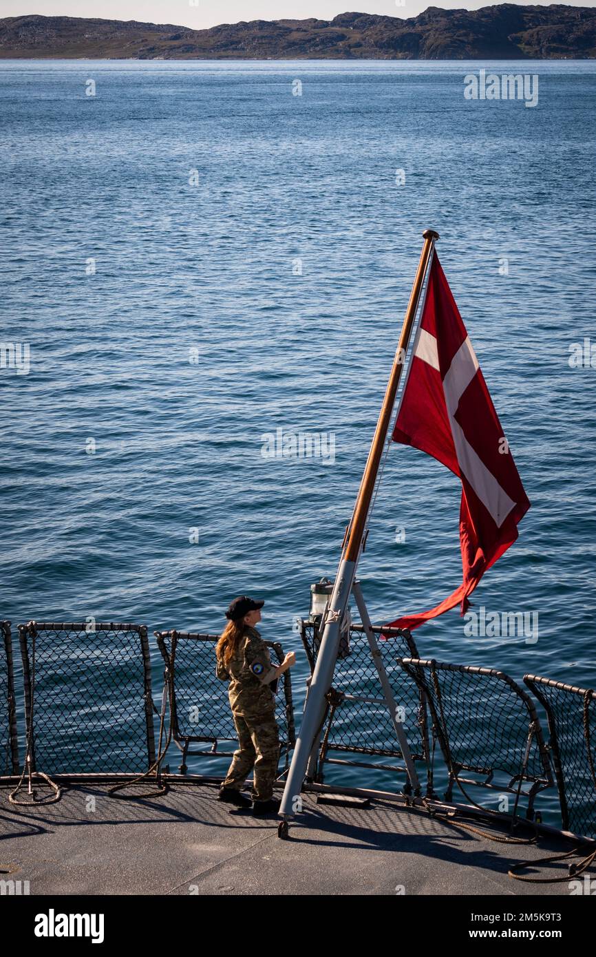 Sailor raises ship's ensign onboard the Royal Danish Navy's patrol ship ...