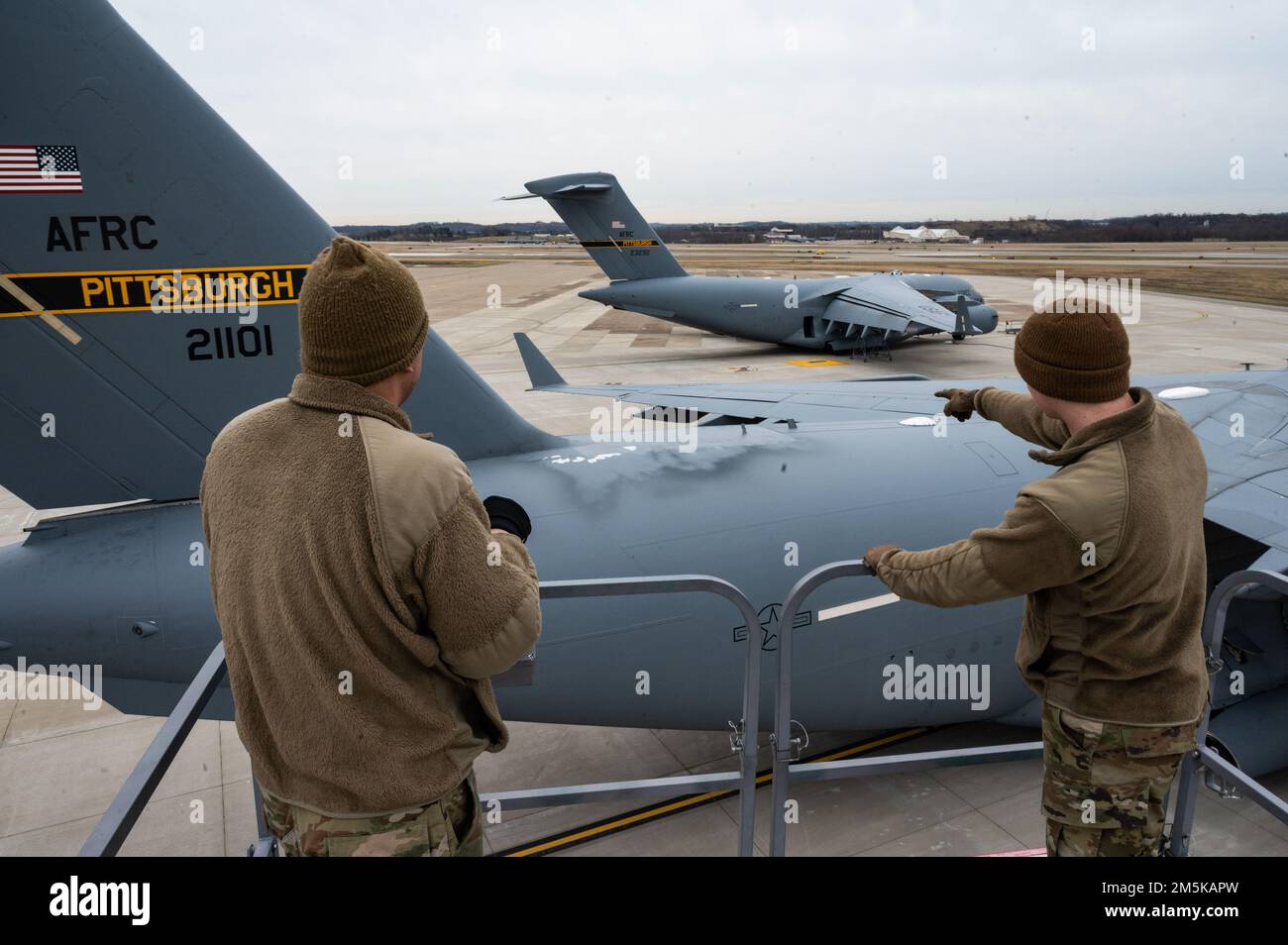 Airmen assigned to the 911th Aircraft Maintenance Squadron inspect the ...