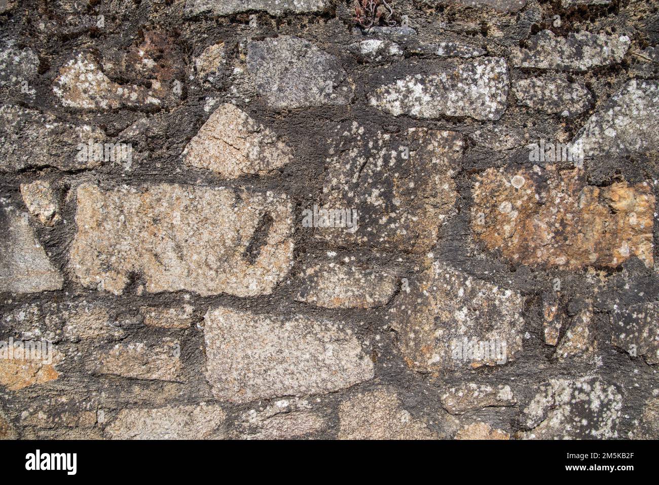 Natural stone wall as background or texture Stock Photo - Alamy