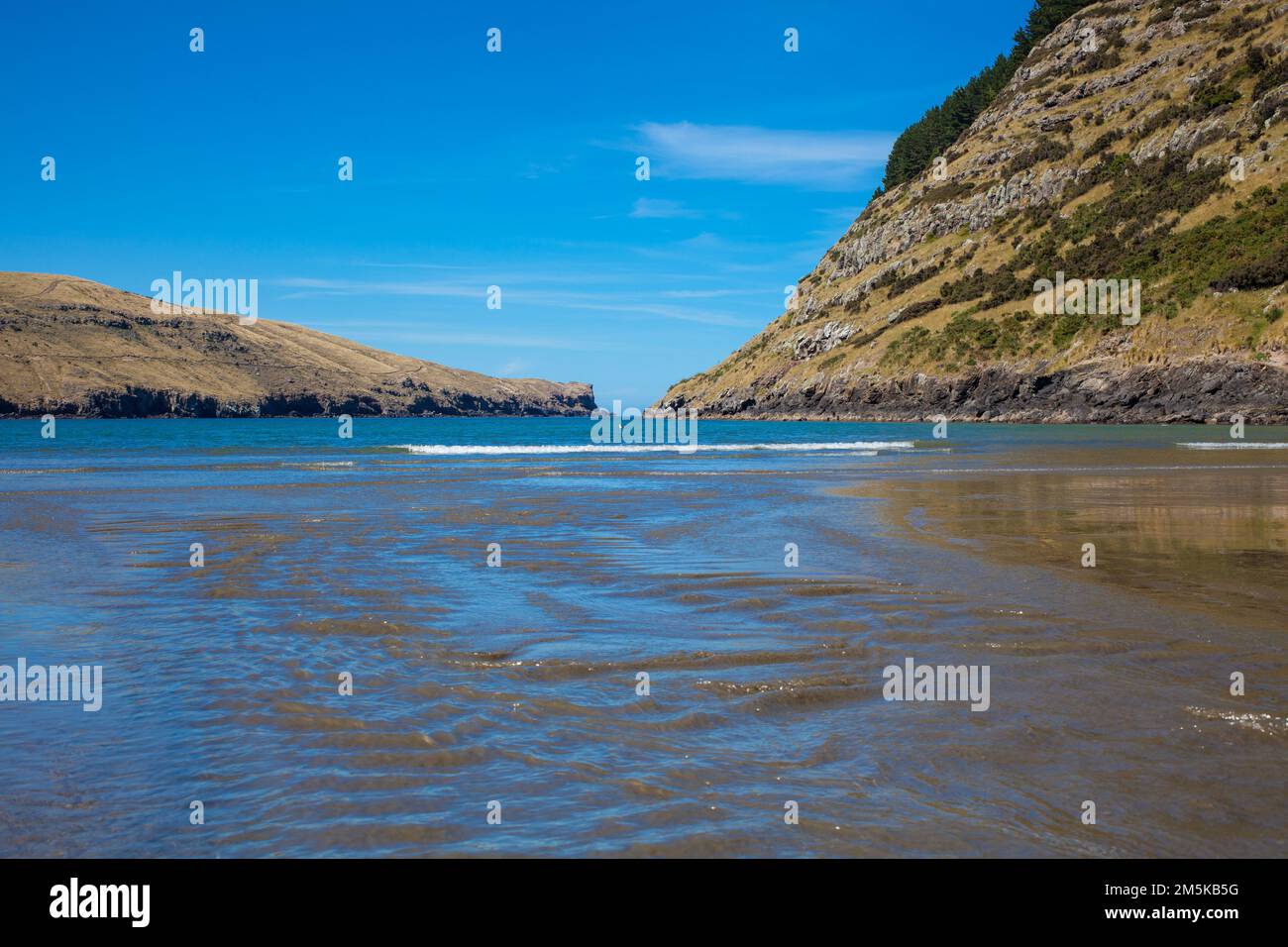 A Look at life in New Zealand: a secluded bay on a rugged coastline ...