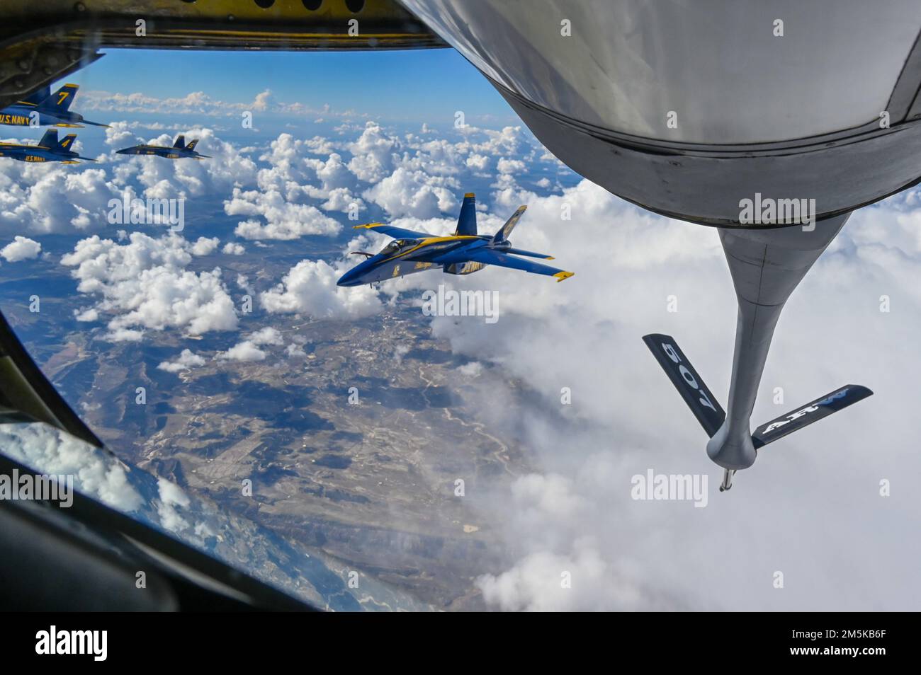 Four U.S. Navy Blue Angel F/A-18E Super Hornets fly behind a KC-135R ...