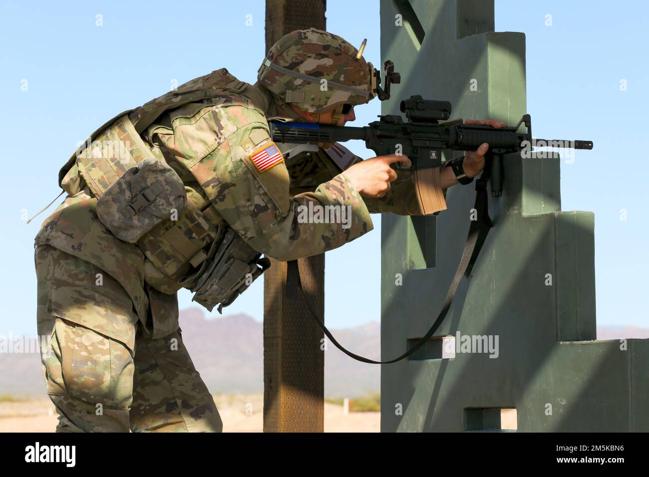 A competitor fires his weapon during the M4 carbine qualification event ...