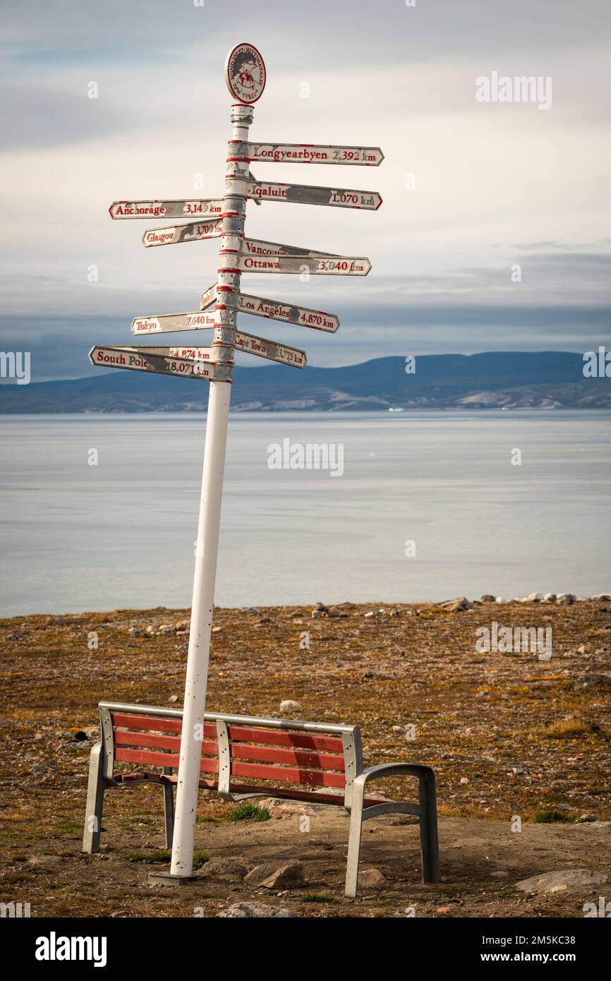 Park bench and distance sign at a viewpoint in Pond Inlet overlooking ...