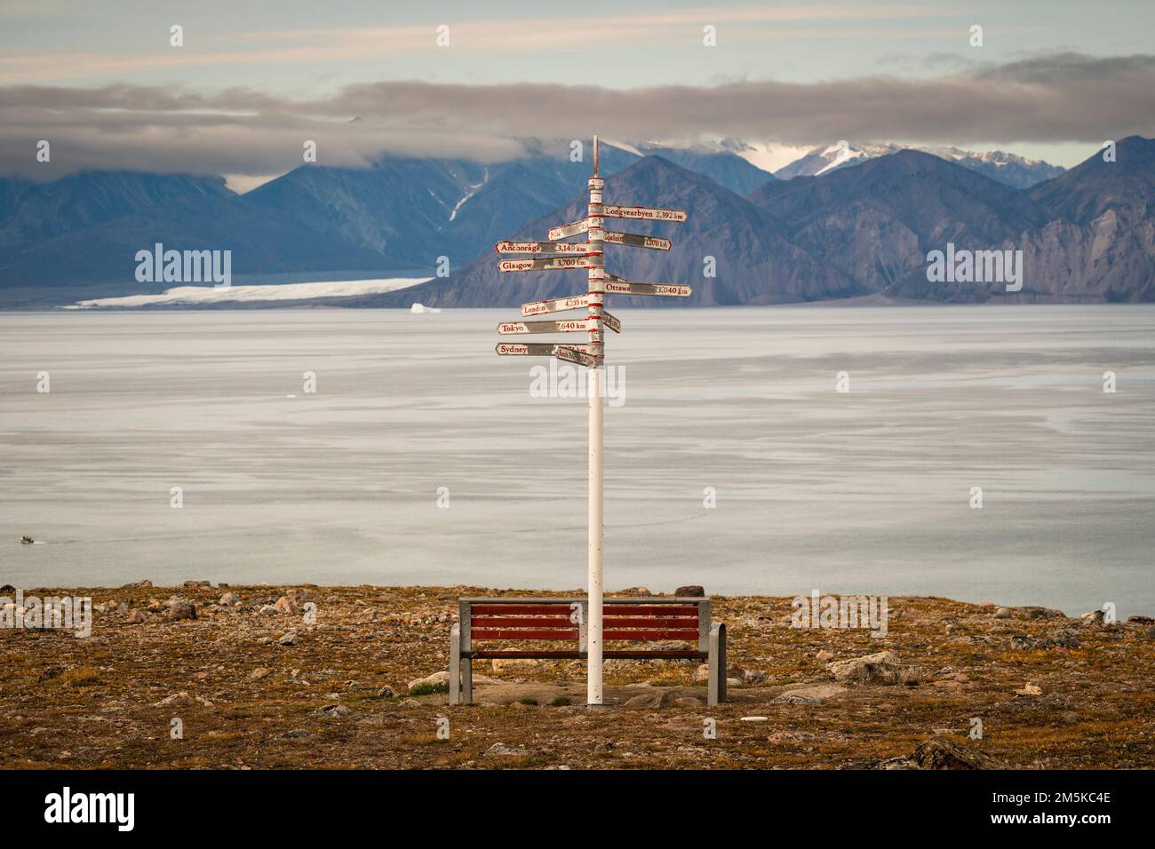 Park bench and distance sign at a viewpoint in Pond Inlet overlooking ...