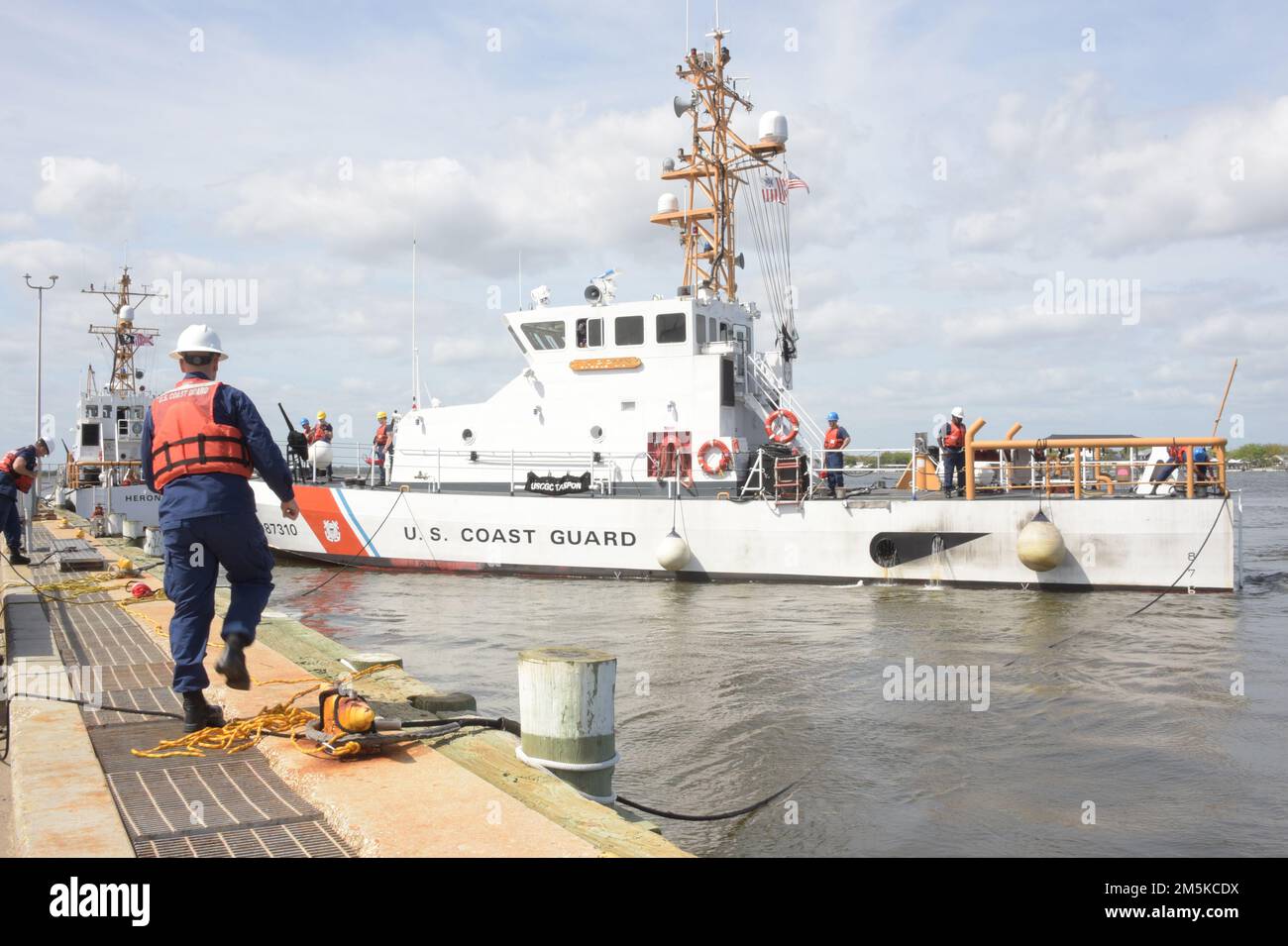 U.S. Coast Guard Petty Officer 1st Class Ian Walter, left, and Petty ...