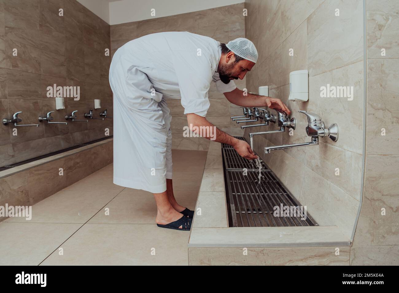 A Muslim performing ablution. Ritual religious cleansing of Muslims ...