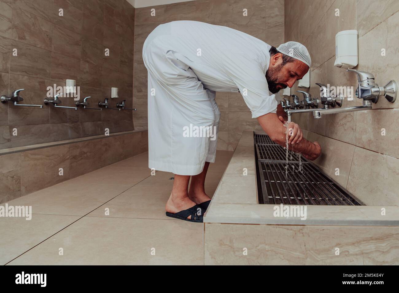A Muslim performing ablution. Ritual religious cleansing of Muslims ...