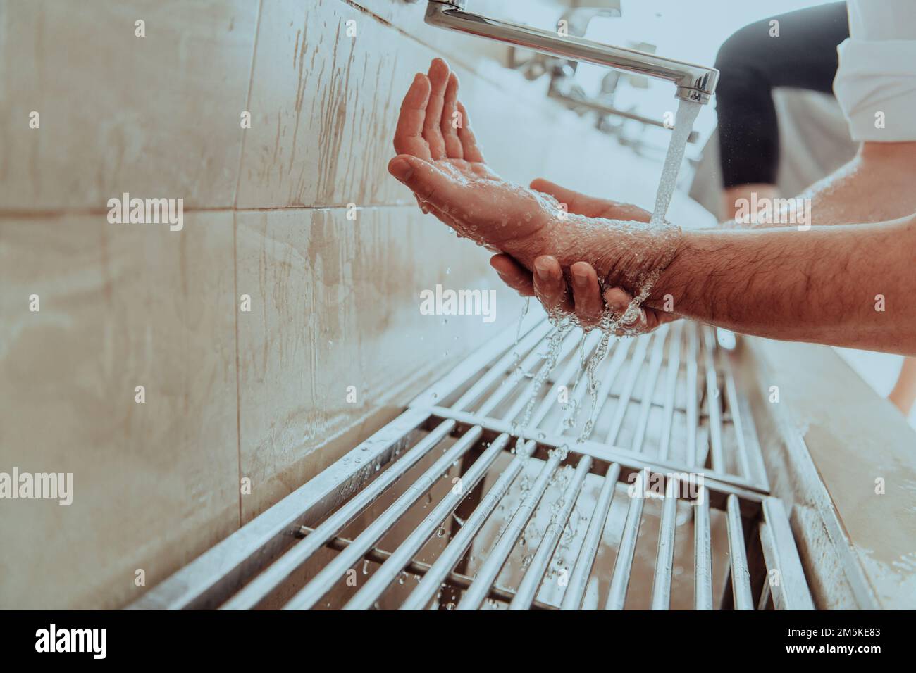 A Muslim performing ablution. Ritual religious cleansing of Muslims ...