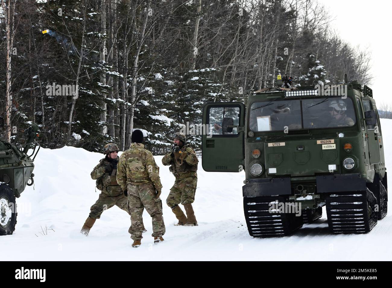 An opposing forces attacker throws a grenade simulator from a small ...
