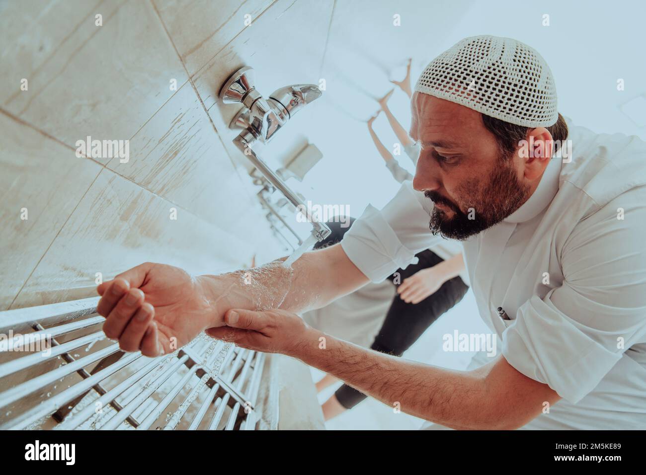 A Muslim performing ablution. Ritual religious cleansing of Muslims ...