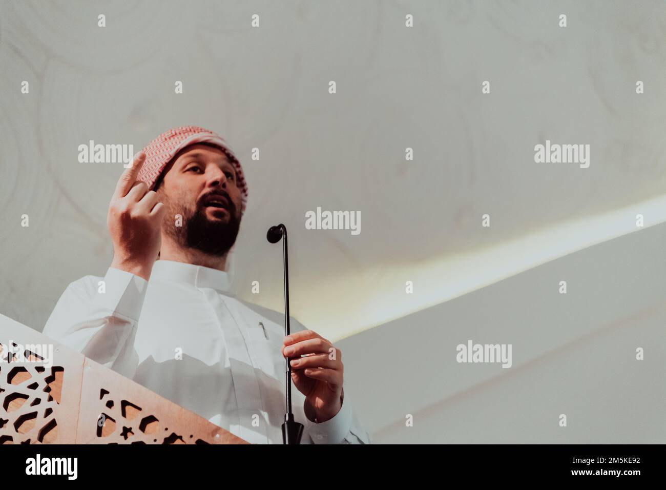 Muslims arabic Imam has a speech on friday afternoon prayer in mosque ...