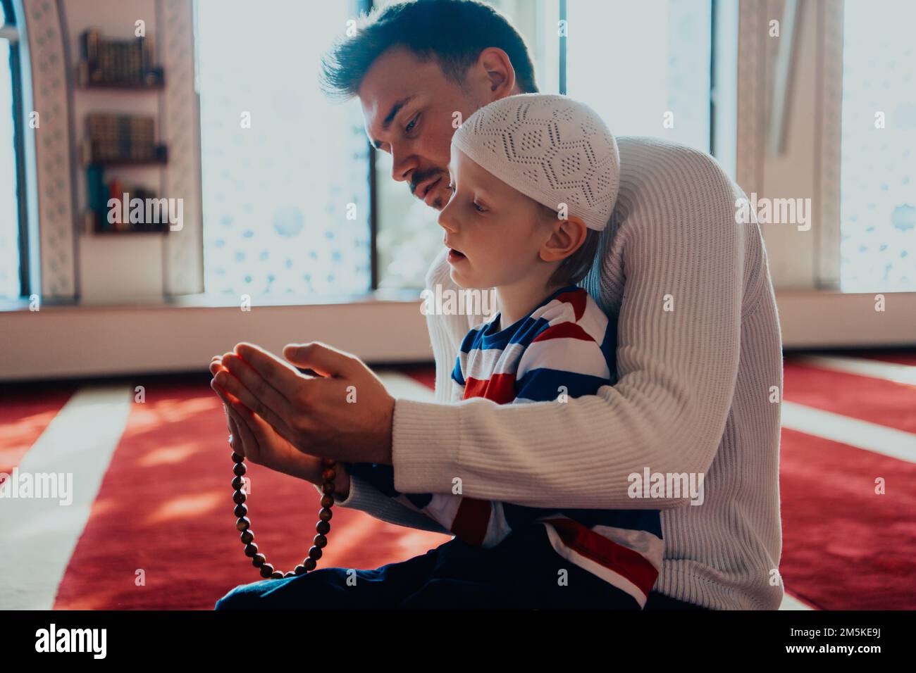 Muslim prayer father and son in mosque prayingtogether Stock Photo - Alamy
