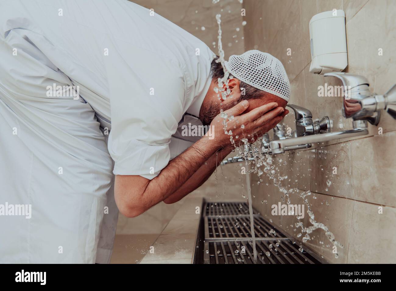 A Muslim performing ablution. Ritual religious cleansing of Muslims ...