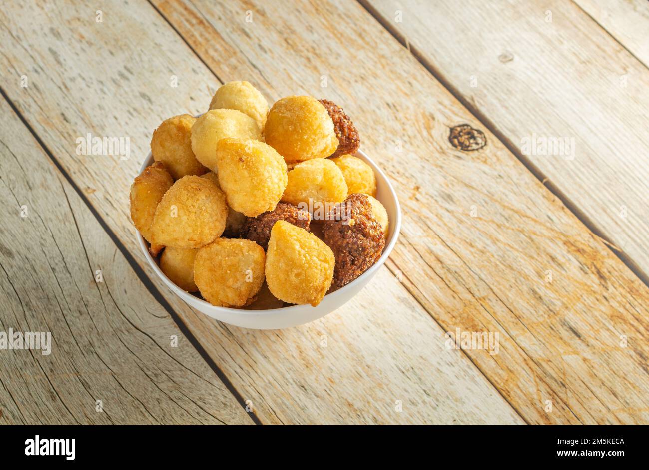 A closeup of traditional brazilian party snack mix with coxinha, kibe ...