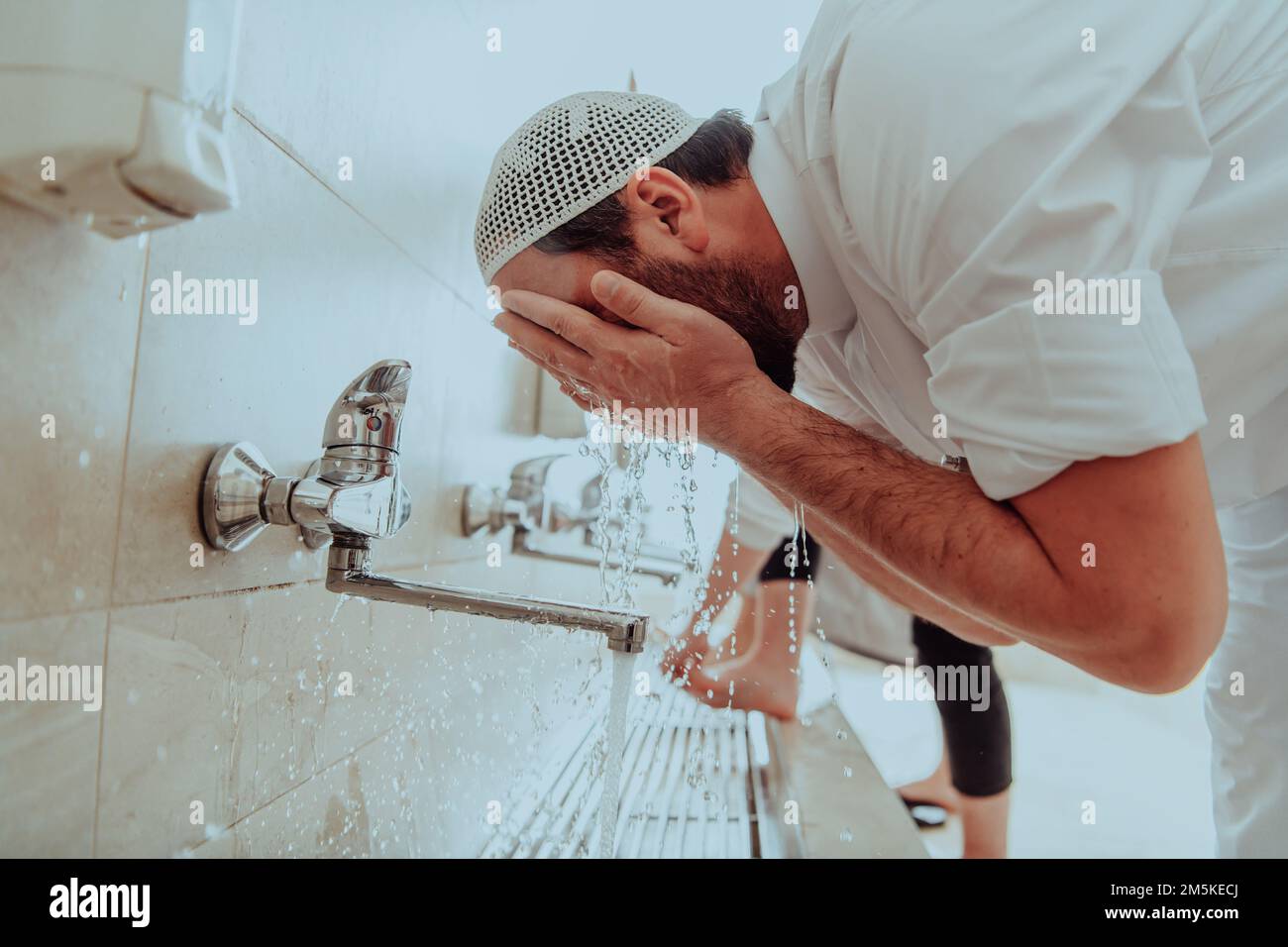 A Muslim performing ablution. Ritual religious cleansing of Muslims ...