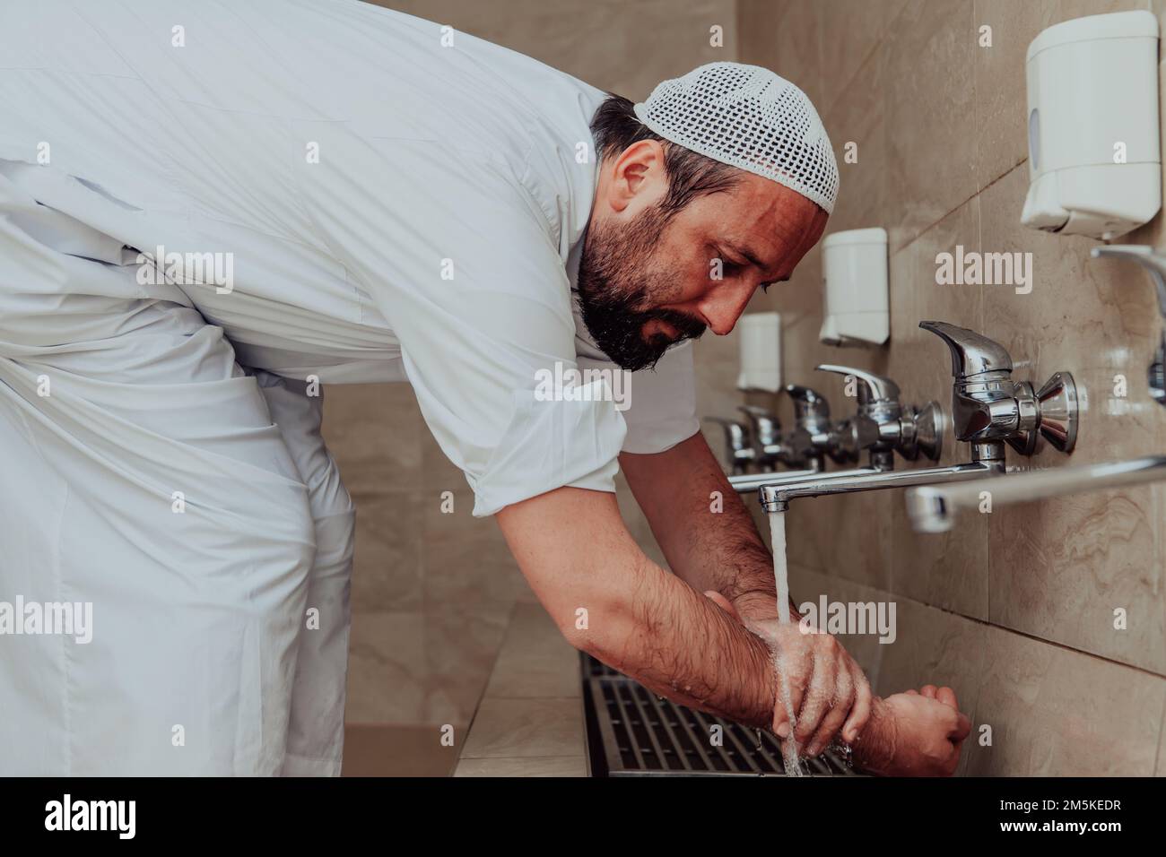 A Muslim performing ablution. Ritual religious cleansing of Muslims ...