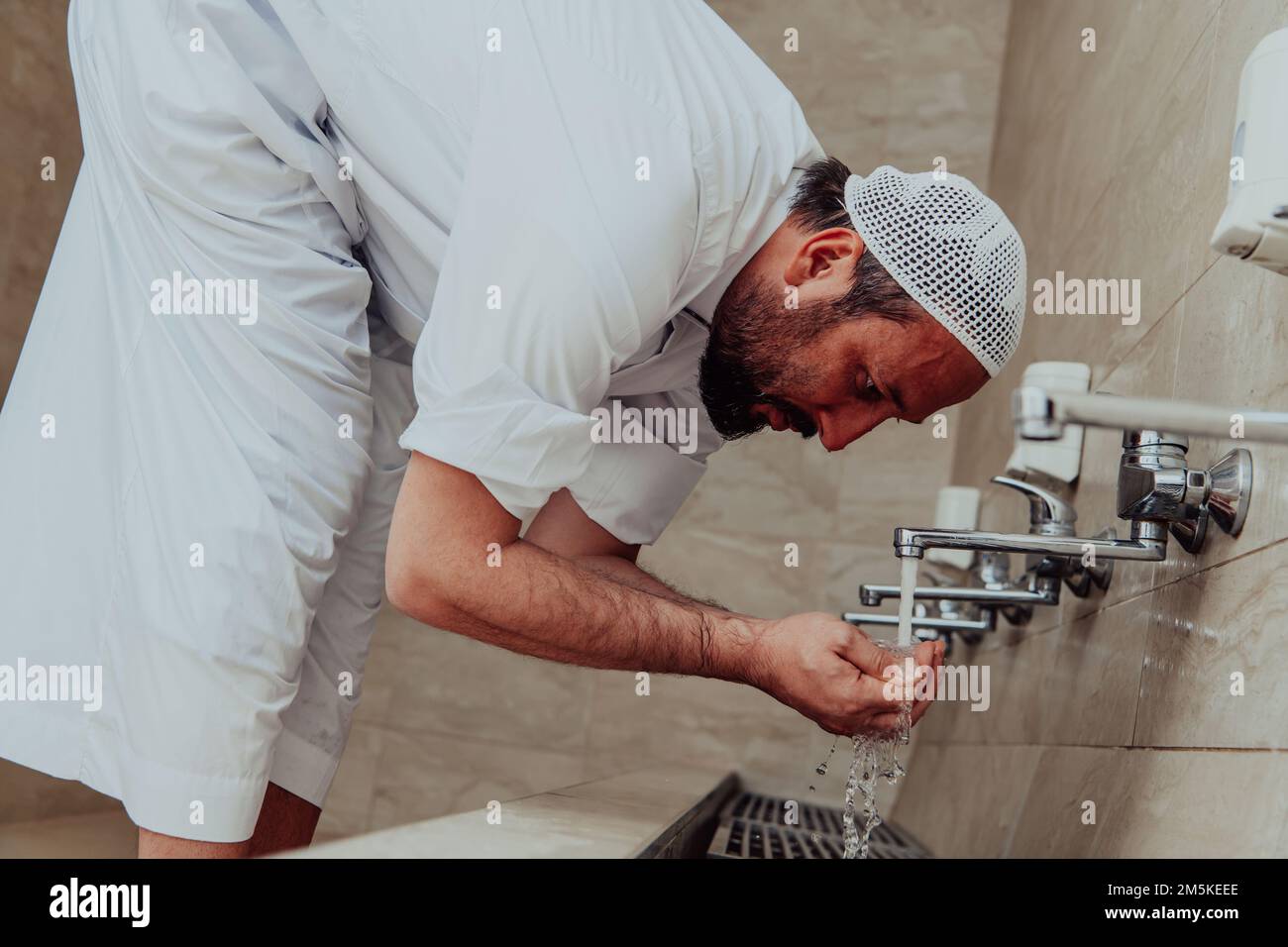 A Muslim performing ablution. Ritual religious cleansing of Muslims ...