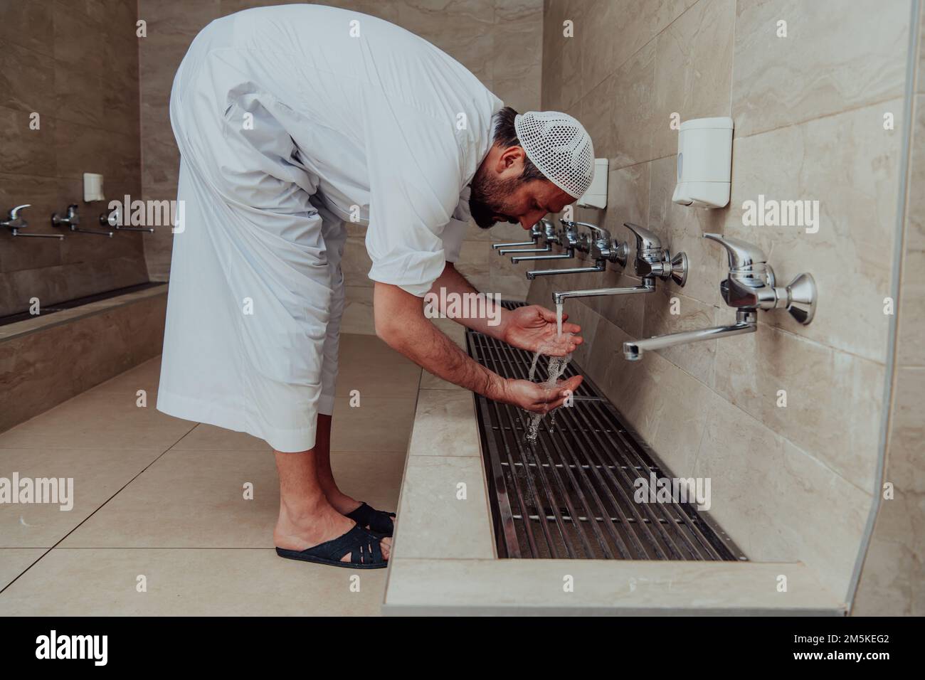 A Muslim performing ablution. Ritual religious cleansing of Muslims ...
