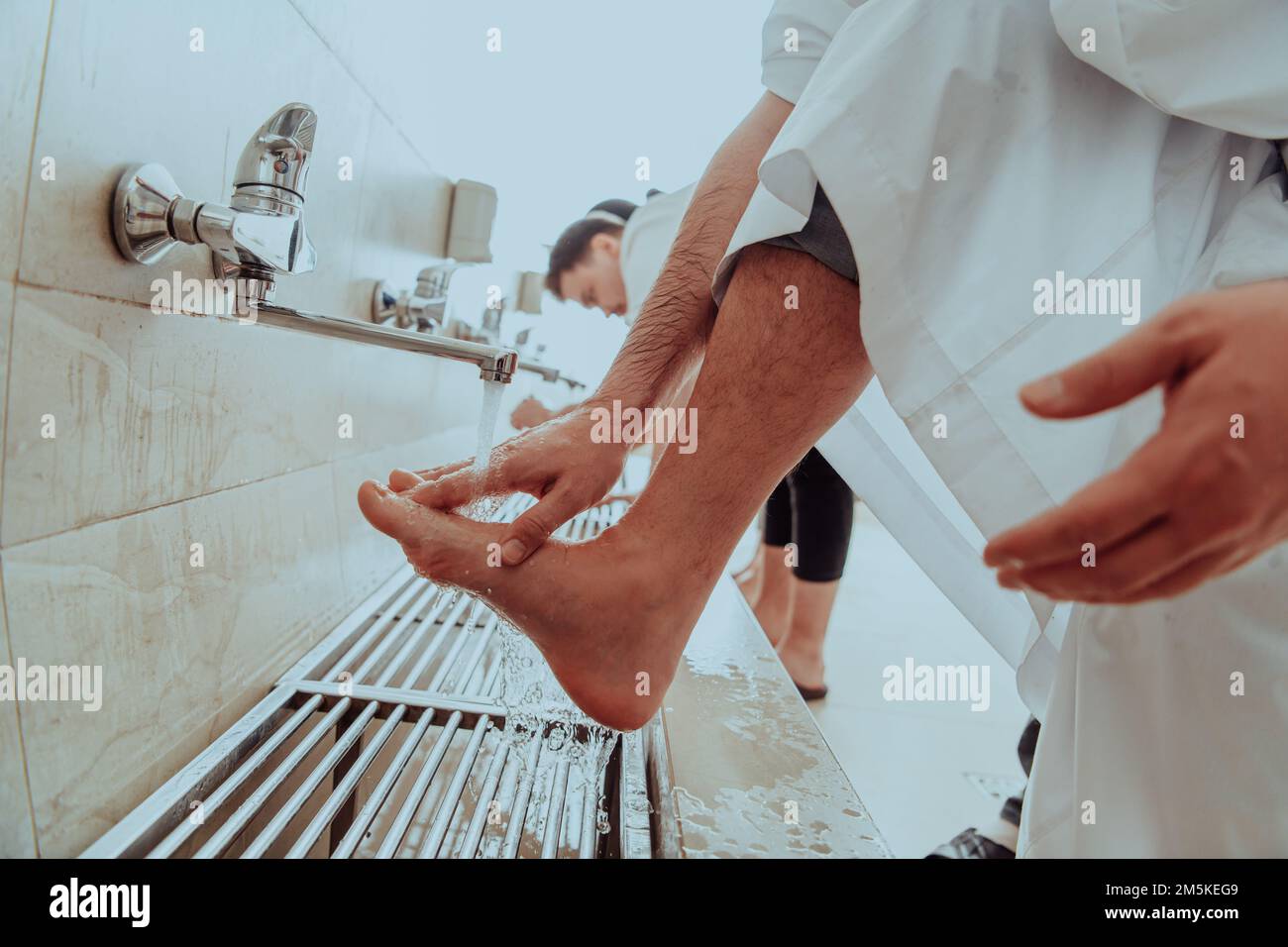 A Muslim performing ablution. Ritual religious cleansing of Muslims ...