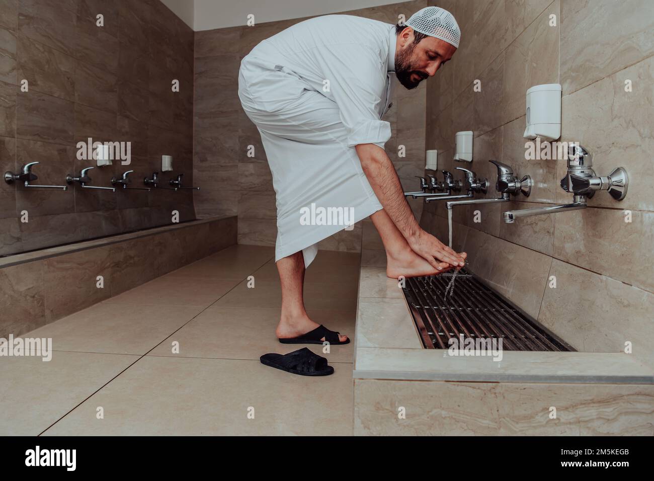 A Muslim performing ablution. Ritual religious cleansing of Muslims ...