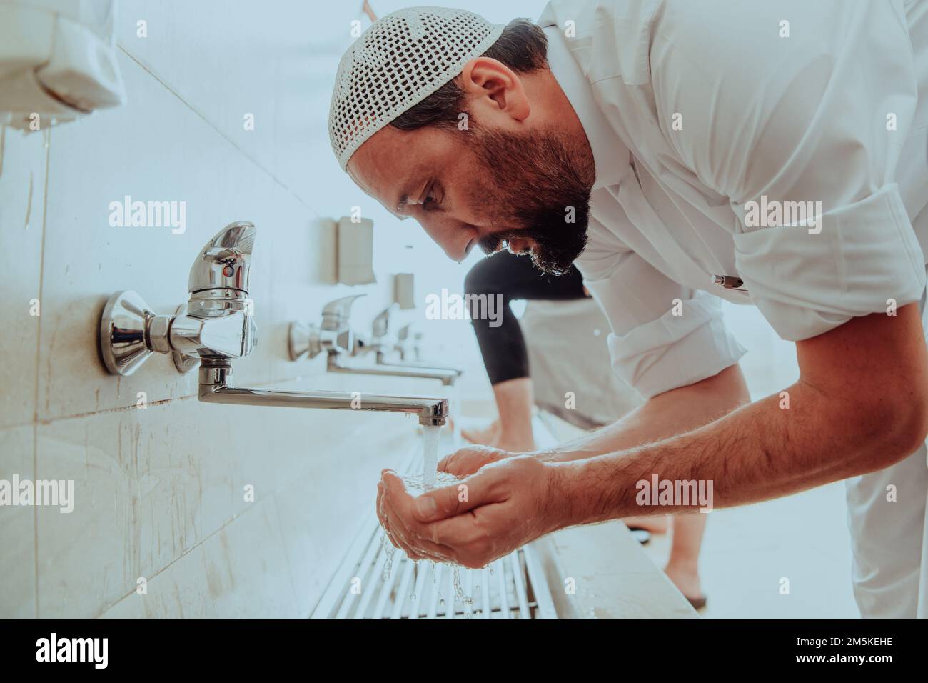 A Muslim performing ablution. Ritual religious cleansing of Muslims ...