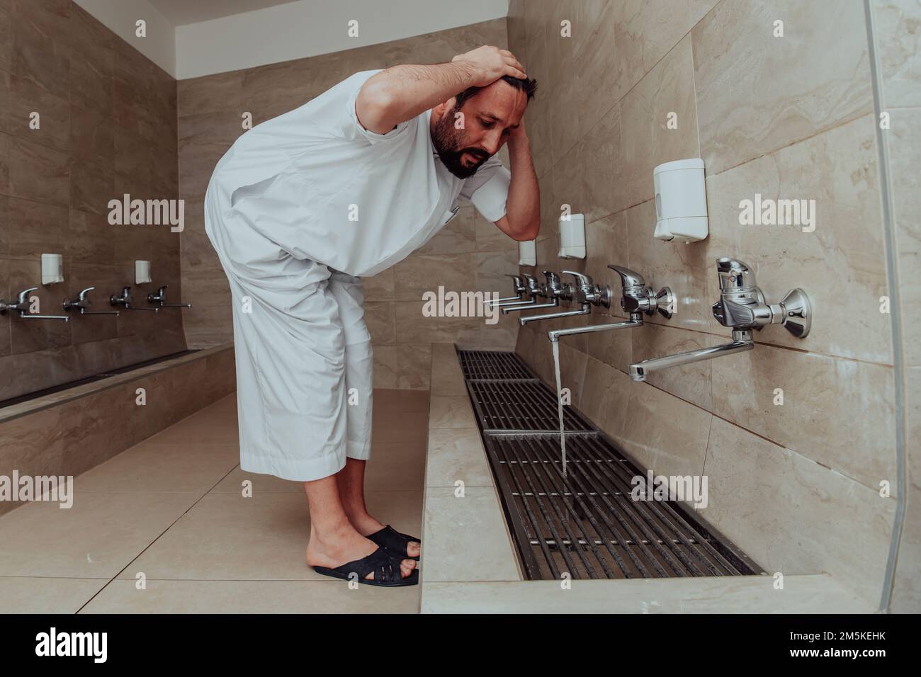 A Muslim performing ablution. Ritual religious cleansing of Muslims ...