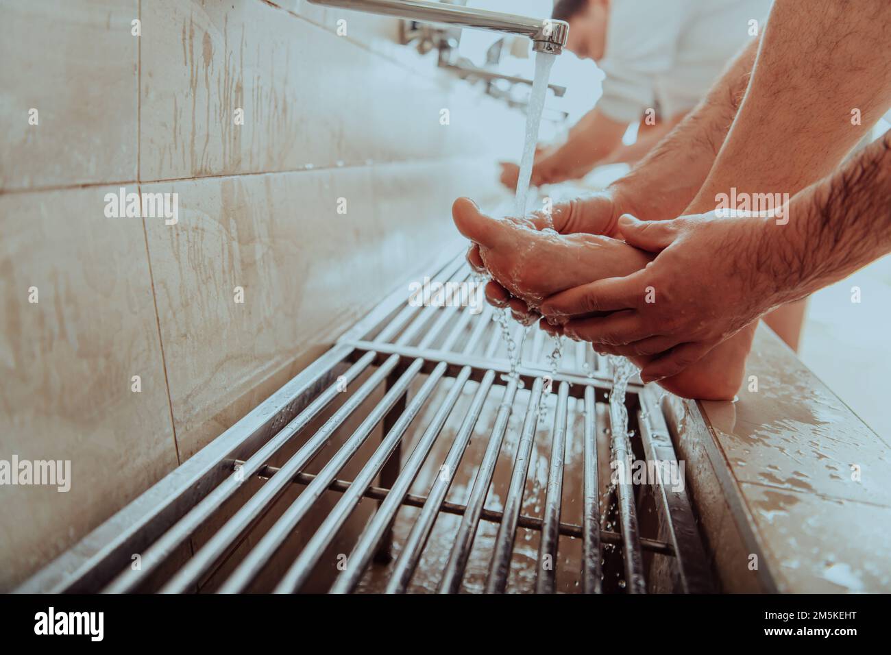 A Muslim performing ablution. Ritual religious cleansing of Muslims ...