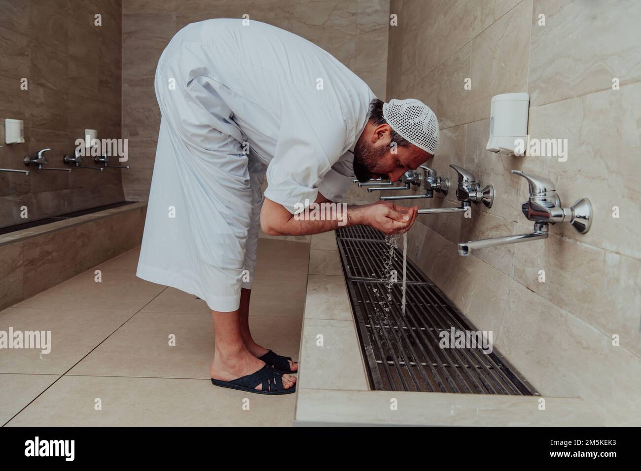 A Muslim performing ablution. Ritual religious cleansing of Muslims ...