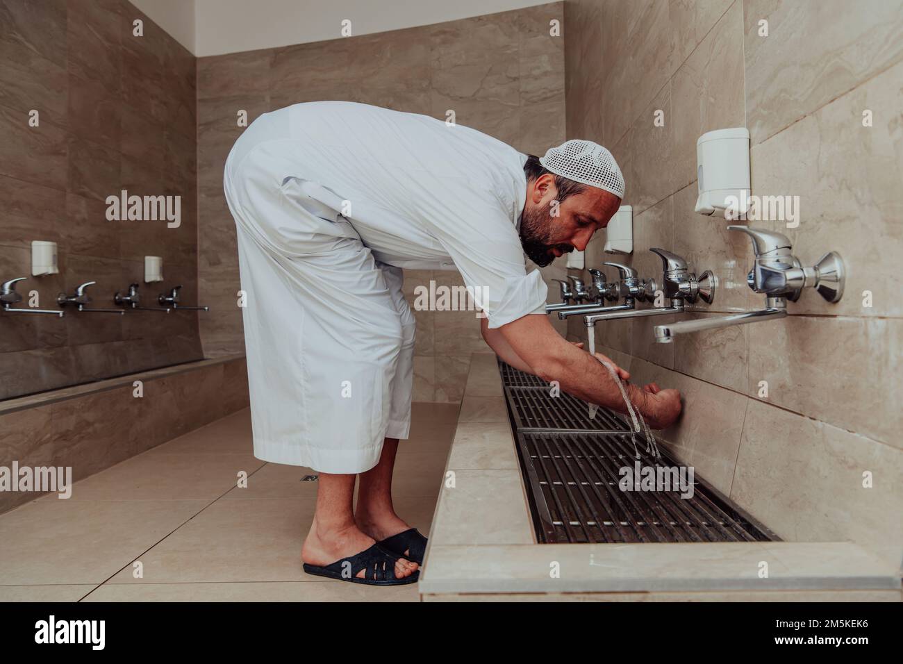 A Muslim performing ablution. Ritual religious cleansing of Muslims ...