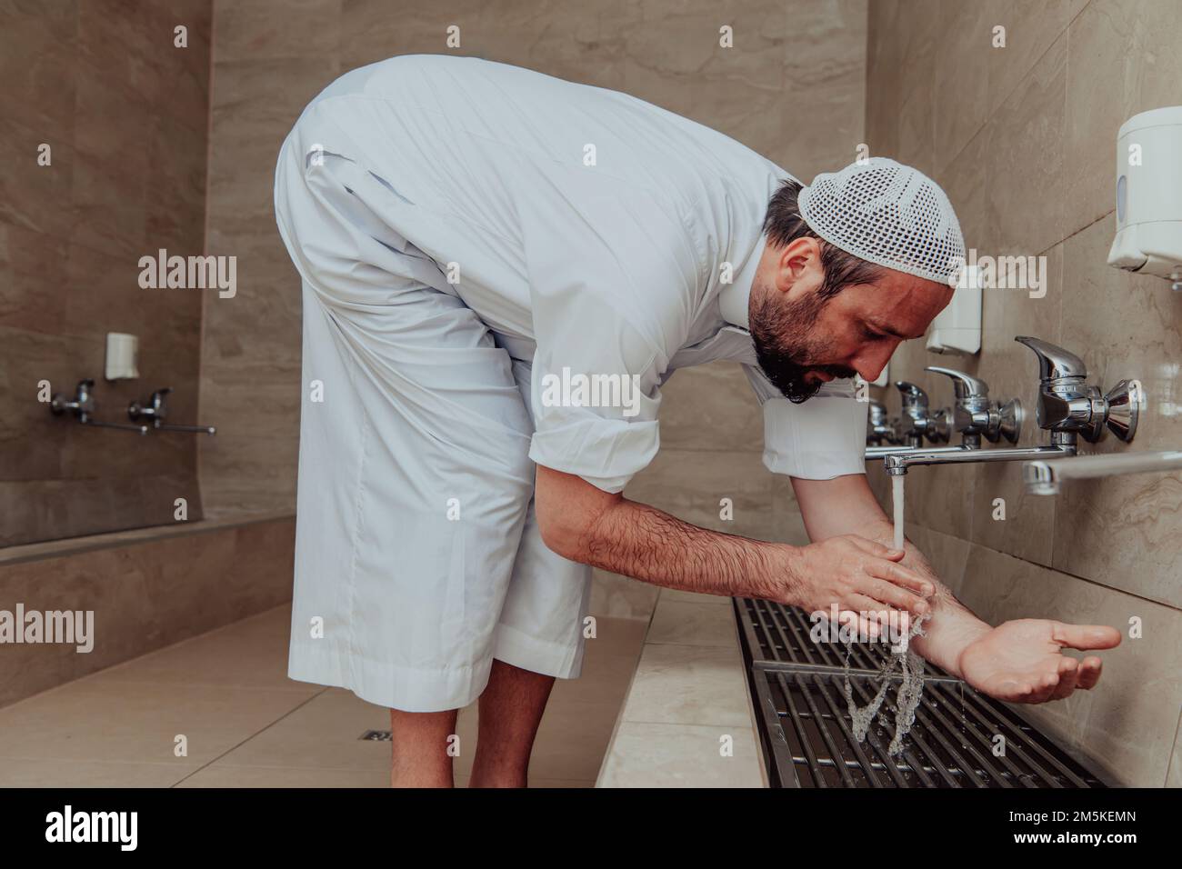 A Muslim performing ablution. Ritual religious cleansing of Muslims ...