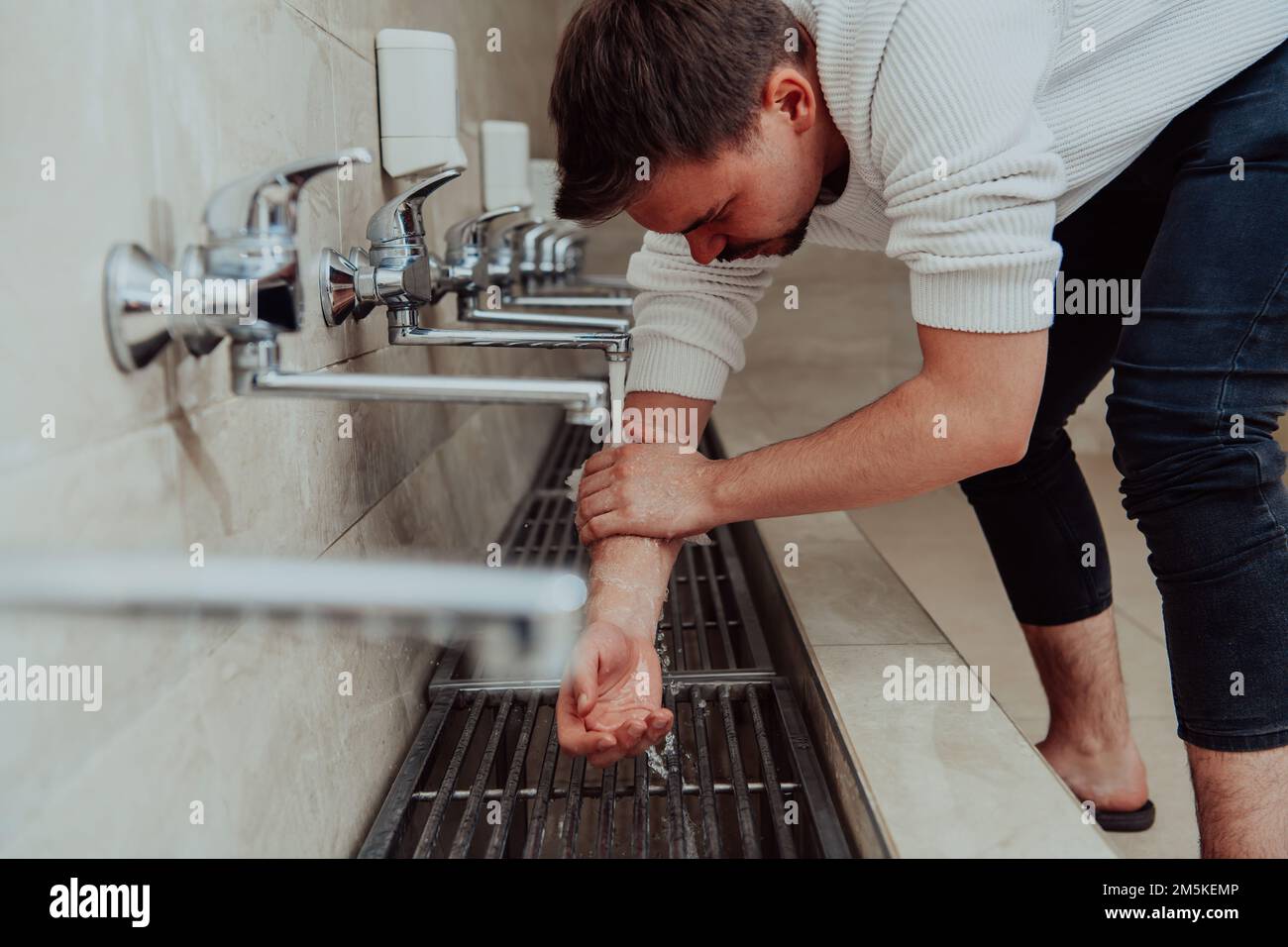 A Muslim performing ablution. Ritual religious cleansing of Muslims ...