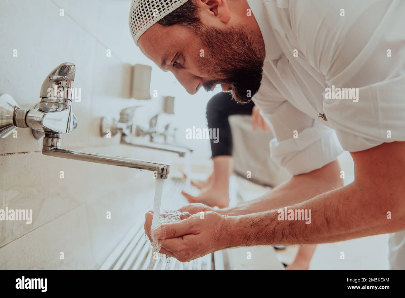 A Muslim performing ablution. Ritual religious cleansing of Muslims ...