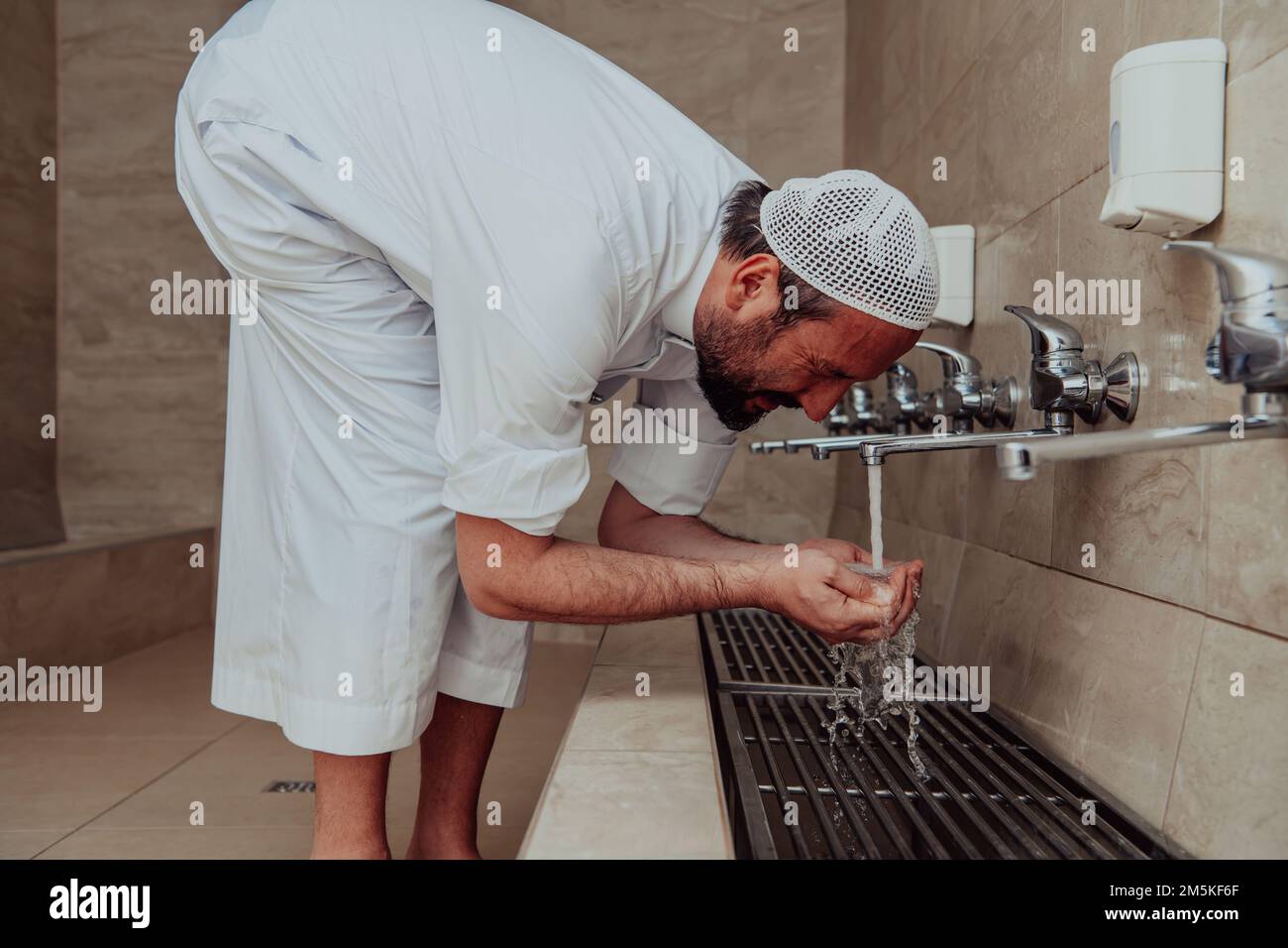 A Muslim performing ablution. Ritual religious cleansing of Muslims ...