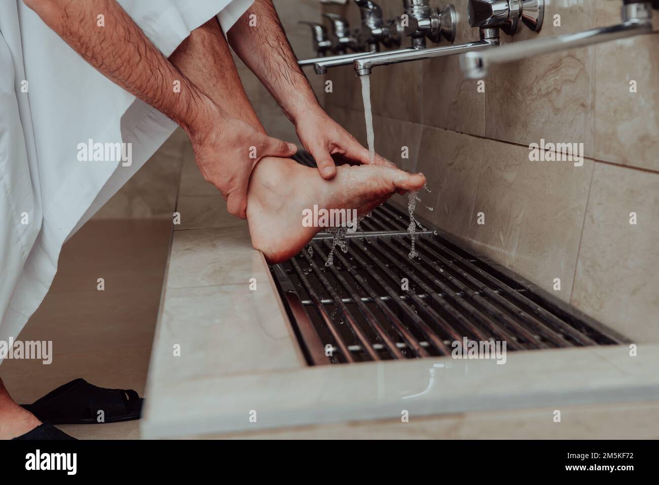 A Muslim performing ablution. Ritual religious cleansing of Muslims ...
