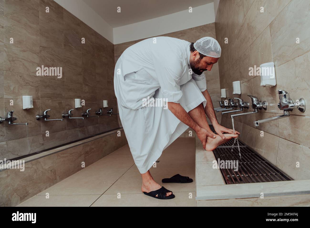 A Muslim performing ablution. Ritual religious cleansing of Muslims ...