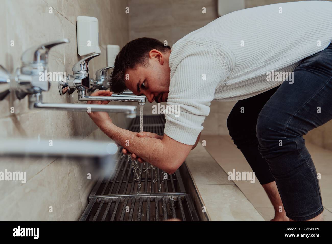 A Muslim performing ablution. Ritual religious cleansing of Muslims ...