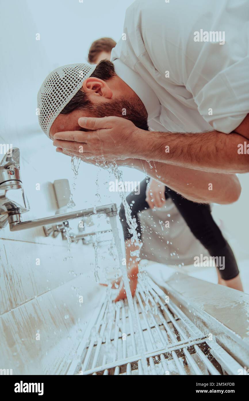 A Muslim performing ablution. Ritual religious cleansing of Muslims ...