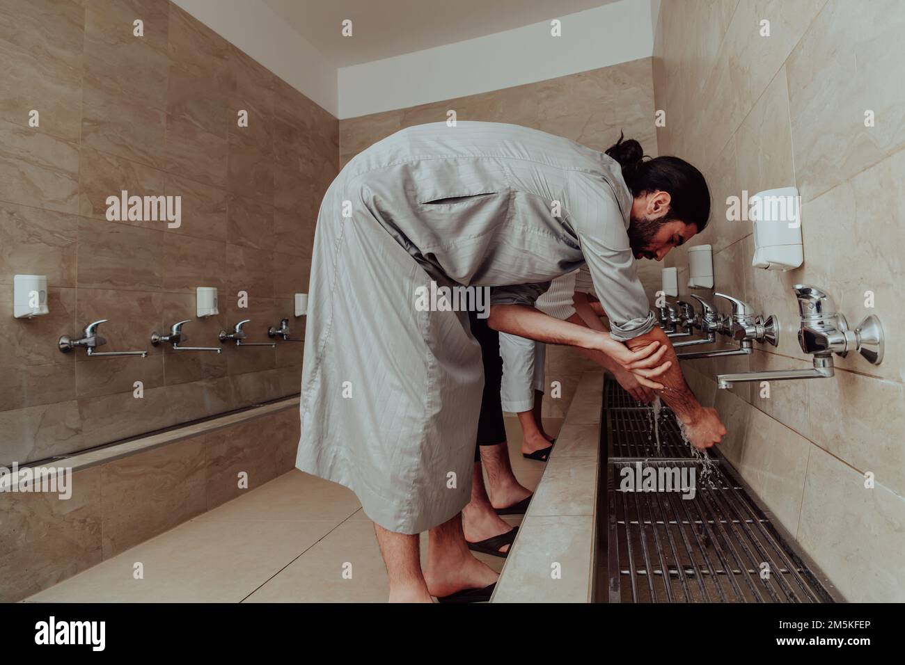 A Muslim performing ablution. Ritual religious cleansing of Muslims ...