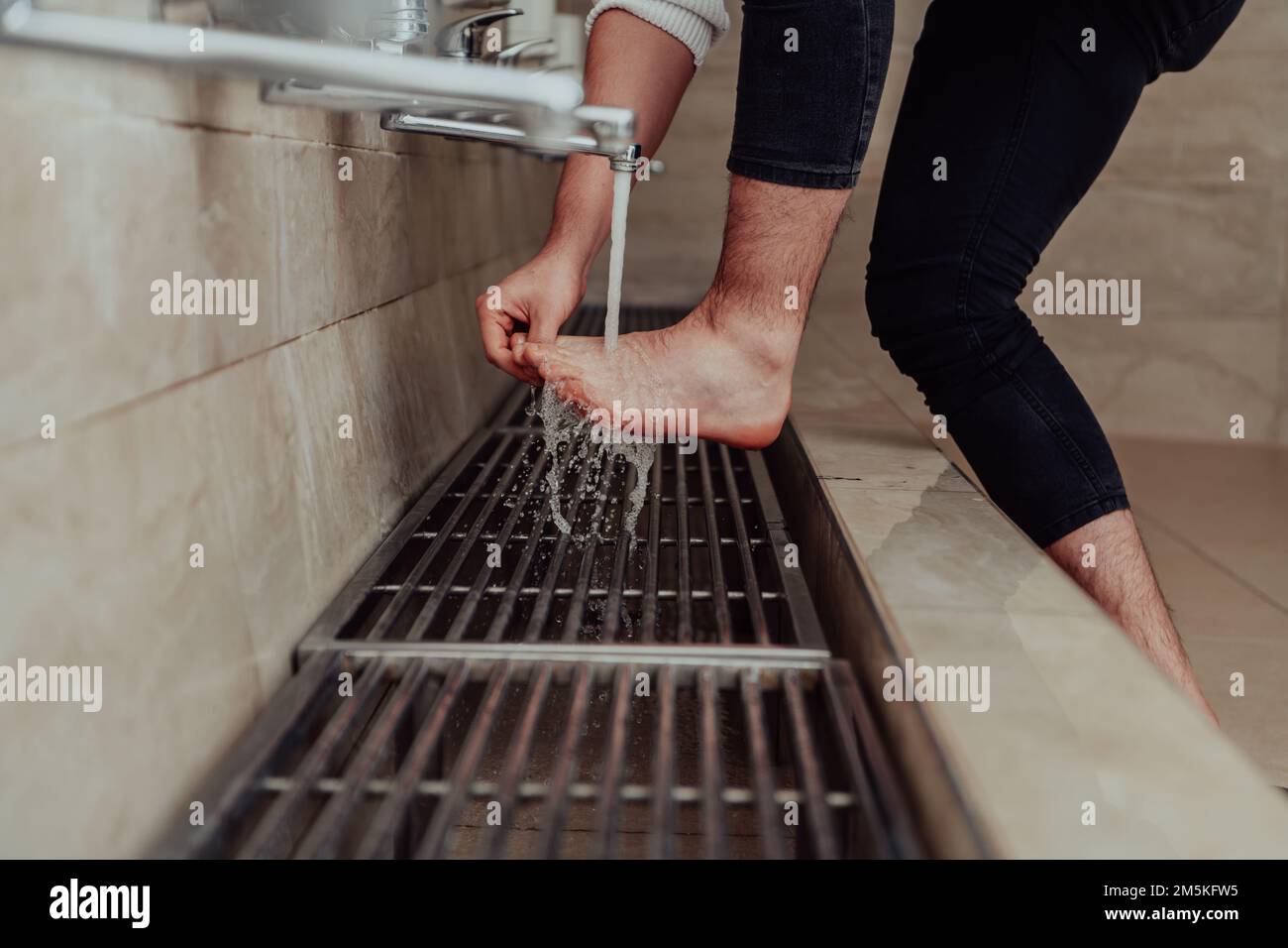 A Muslim performing ablution. Ritual religious cleansing of Muslims ...