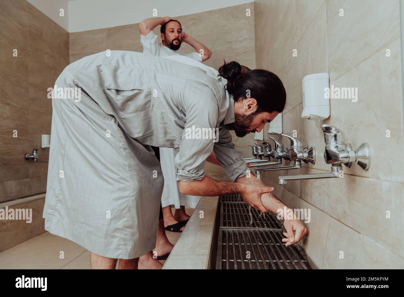 A Muslim performing ablution. Ritual religious cleansing of Muslims ...